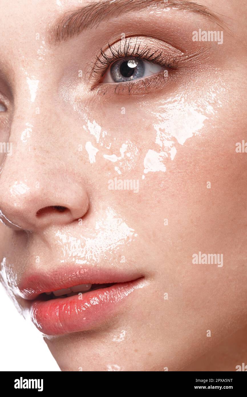 Beautiful young girl with a light natural make-up and perfect wet skin ...