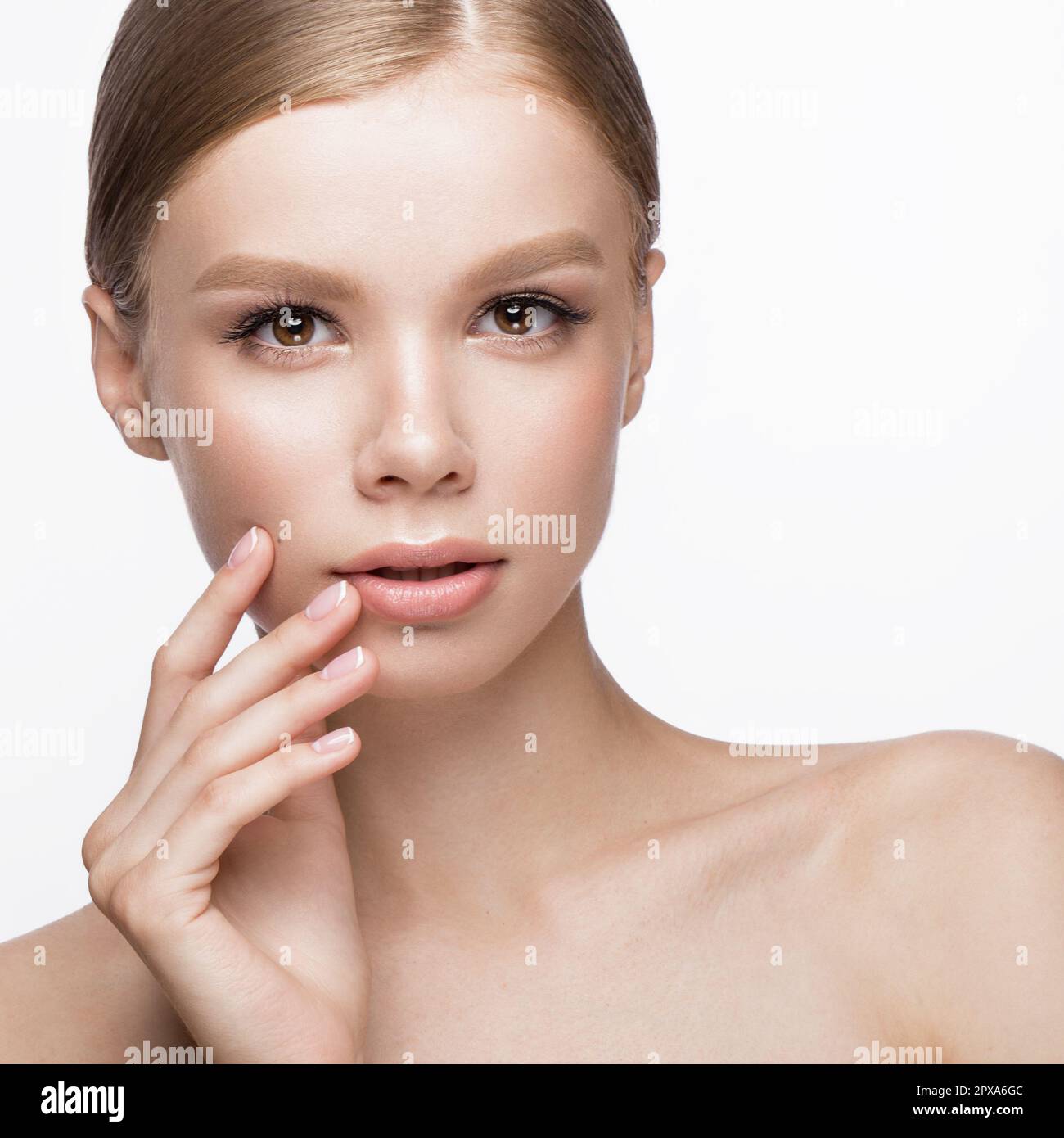 Beautiful young girl with a light natural make-up and French manicure ...