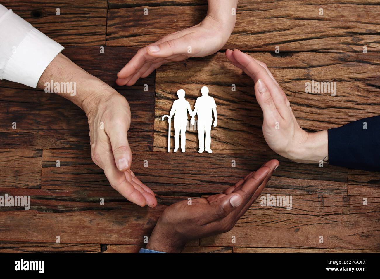 Protecting Senior Couple And Retired Family Figures Stock Photo - Alamy