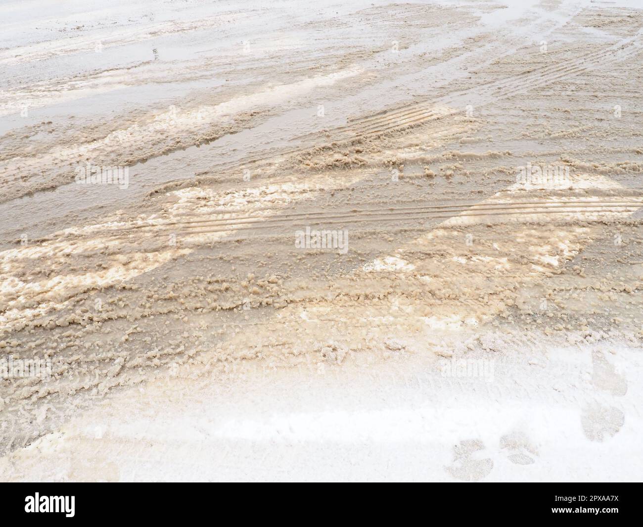 Snow, ice, slush and winter mud at a pedestrian crossing. The air ...