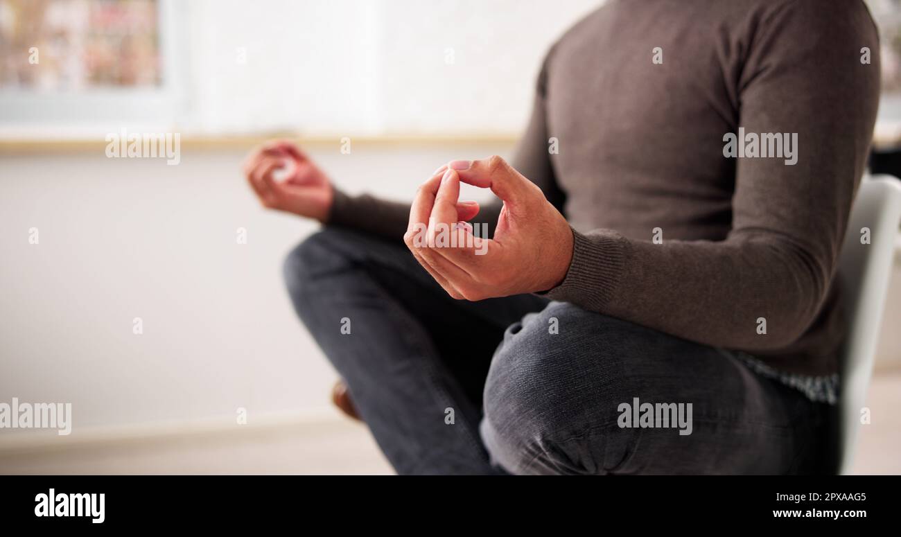 African American Male Meditation In Office Near Computer Stock Photo ...