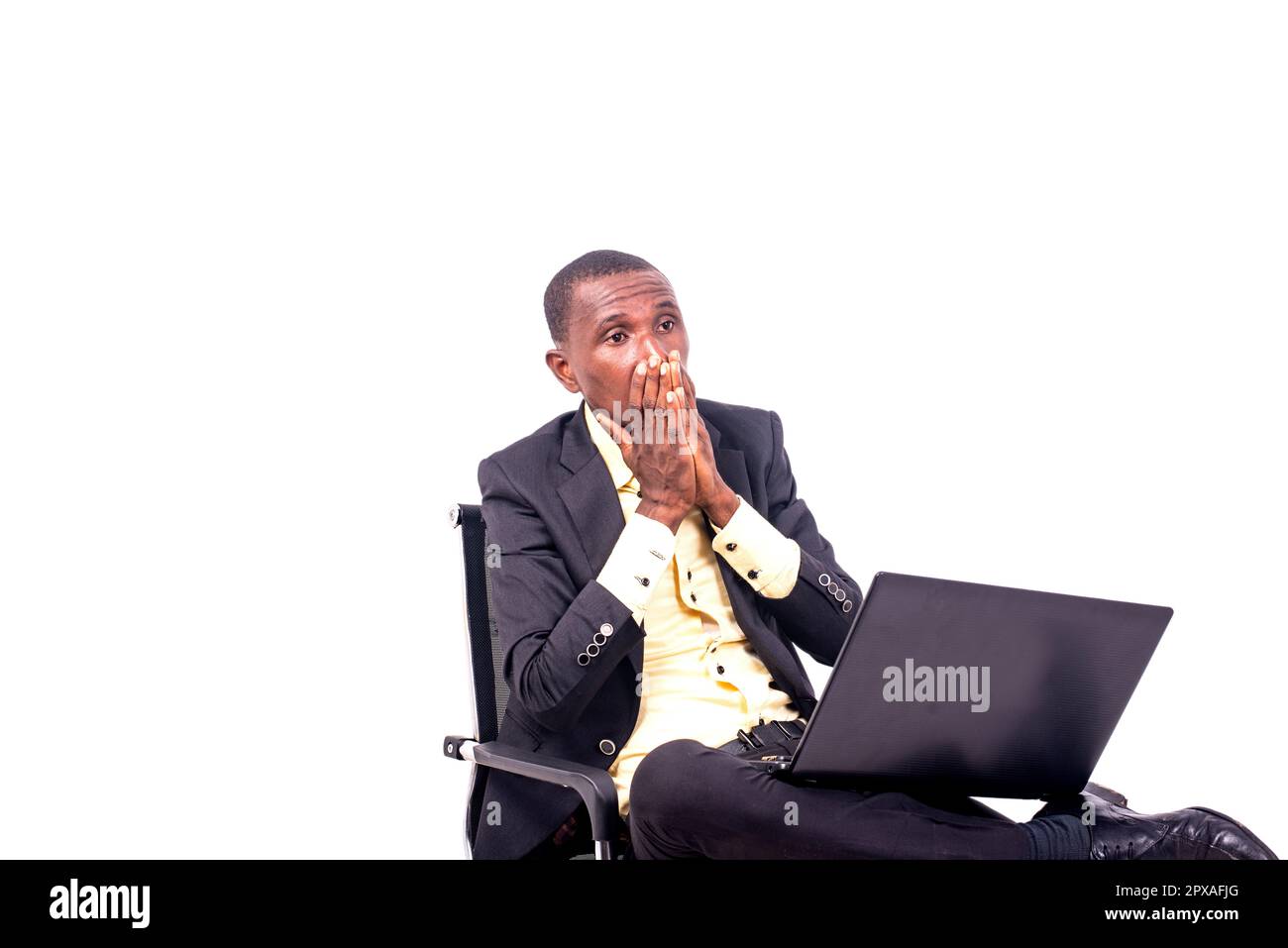 surprised business man with hands over mouth sitting on chair and ...