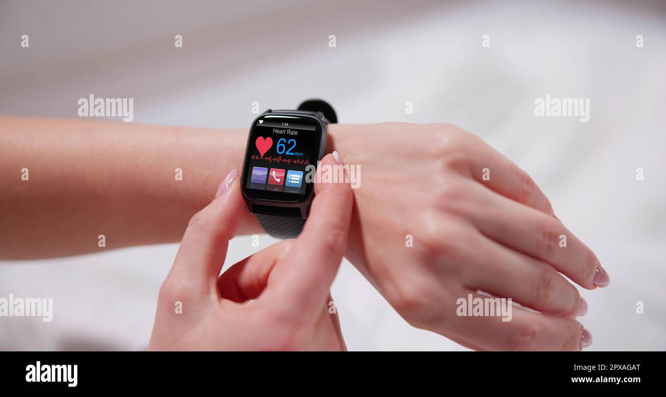 Smart Watch Showing Heartbeat Monitor On Woman's Hand Stock Photo - Alamy