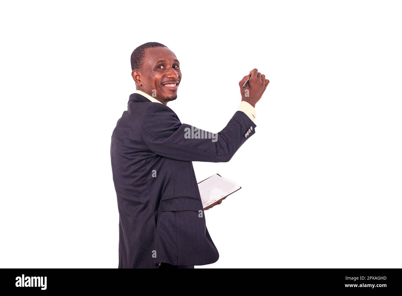 smiling portrait of young teacher holding notebook and writing on ...