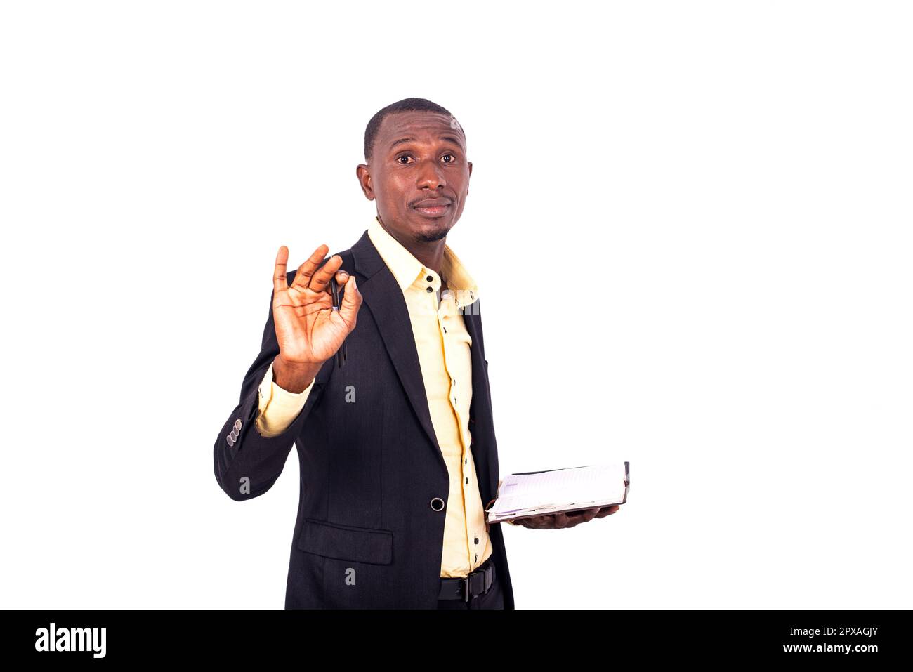 portrait of a serious young teacher holding a notebook and showing the ...