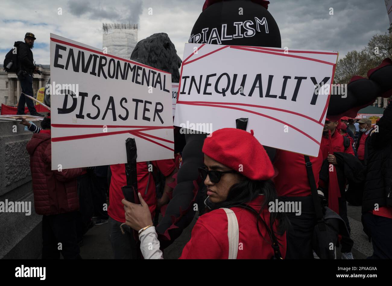 "Environmental Disaster" and "Inequality". A young woman, a May Day ...