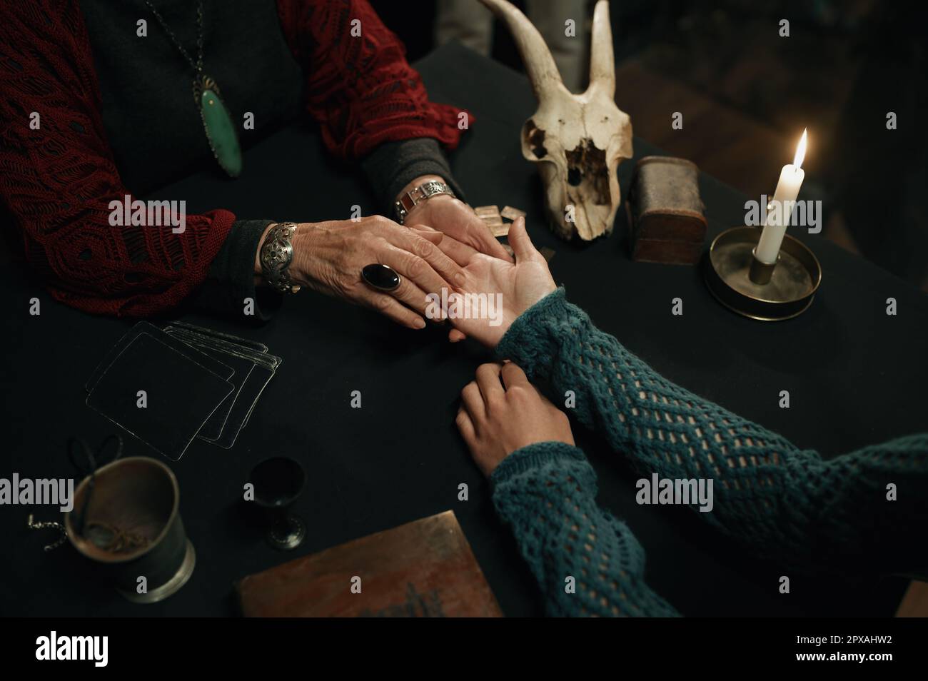 Top view on fortune teller and client hands over table with spiritual ...