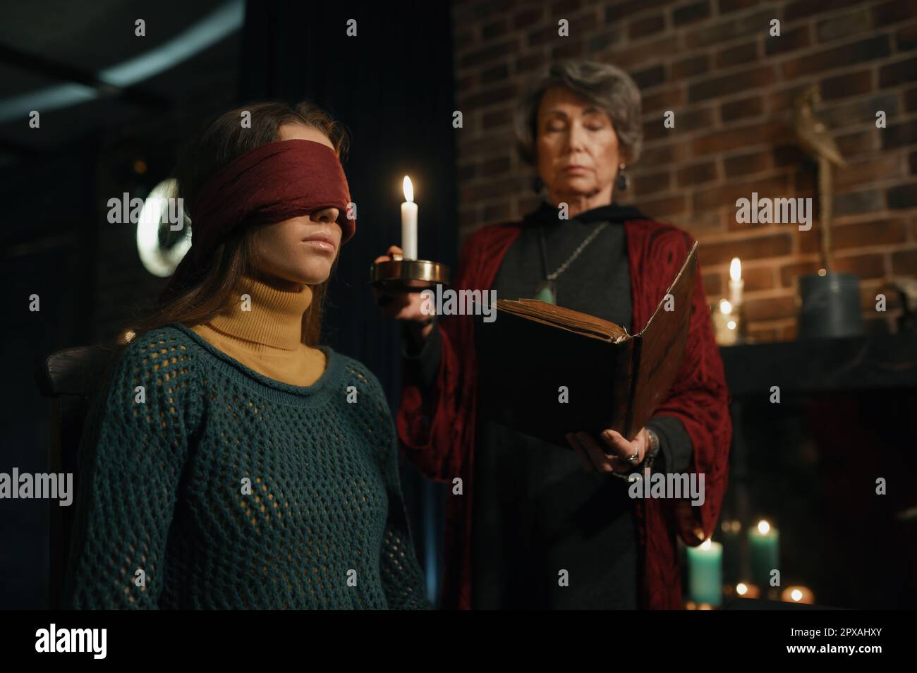 Old mature gypsy fortune teller reading witchcraft spell from book for ...