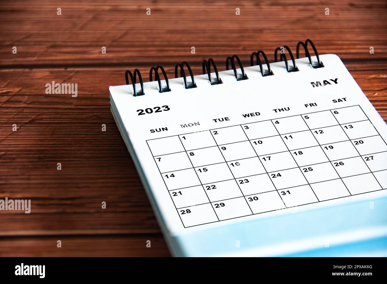 May 2023 white desk calendar on wooden table background Stock Photo - Alamy