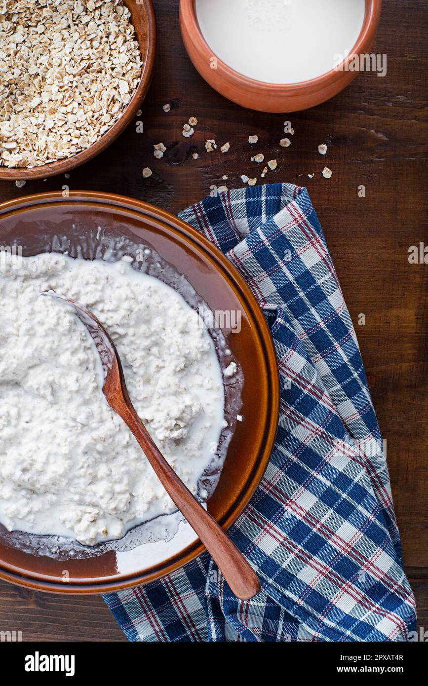 Oatmeal bowl. Cooked oatmeal served with fresh milk. Healthy breakfast ...