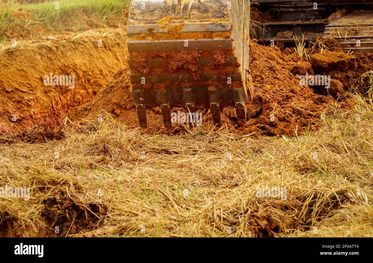 Selective focus on excavator bucket digging soil. Earthwork. Dirt metal ...