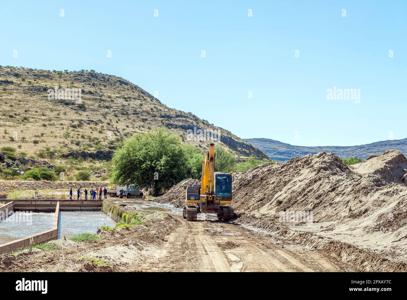 Boegoeberg Dam, South Africa - Feb 28 2023: A backhoe loader clearing ...