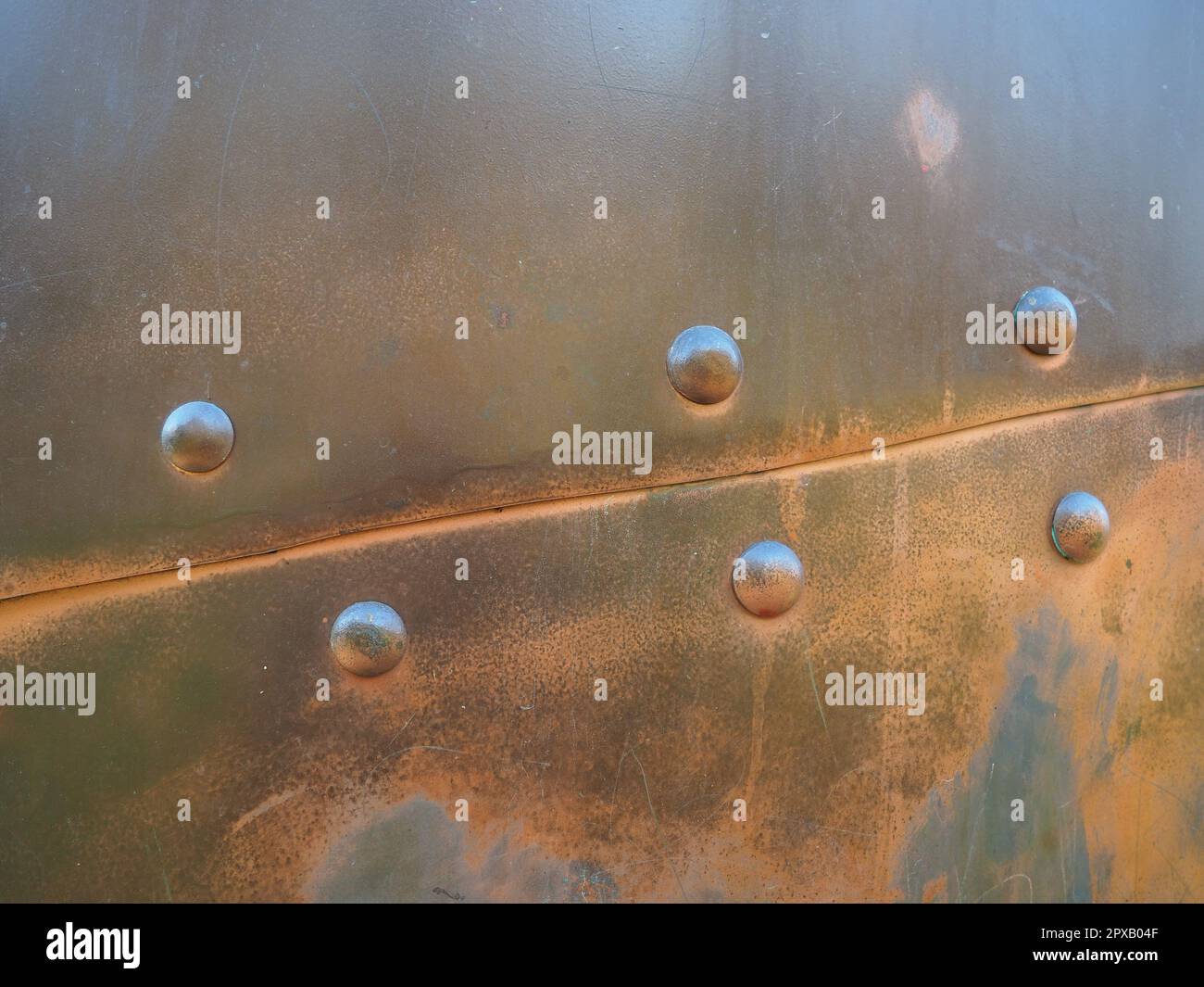 Metal surface with rivets and bolts. Abstract background of a military ...
