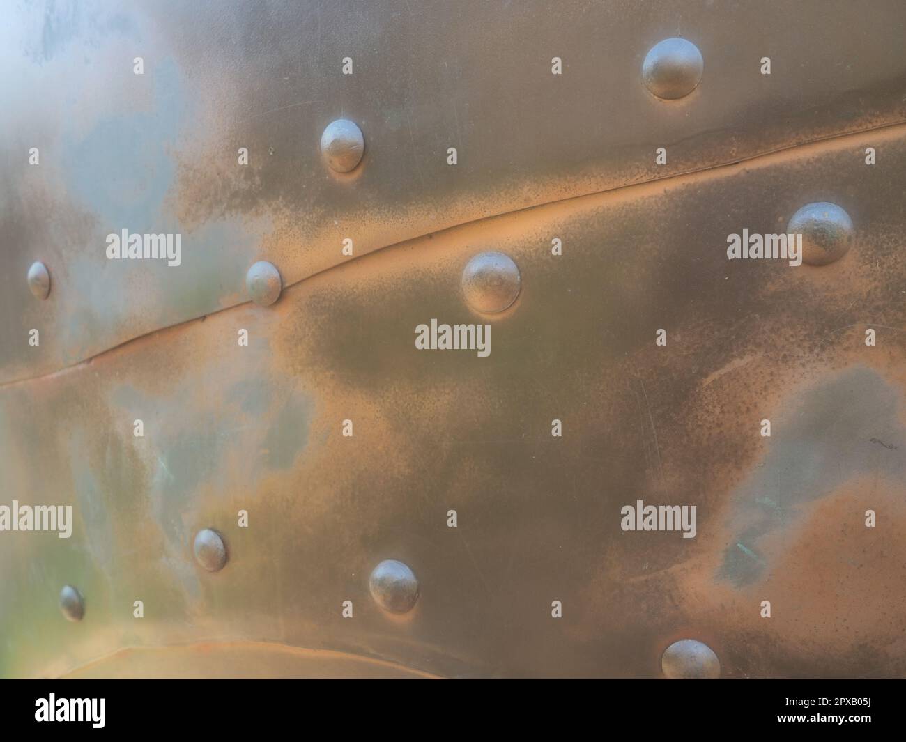 Metal surface with rivets and bolts. Abstract background of a military ...