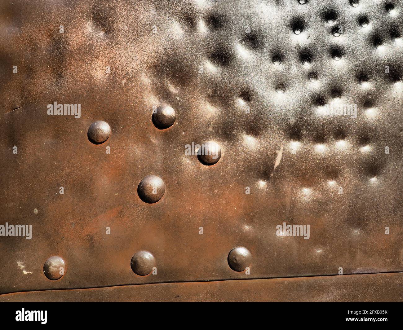 Metal surface with rivets and bolts. Abstract background of a military ...