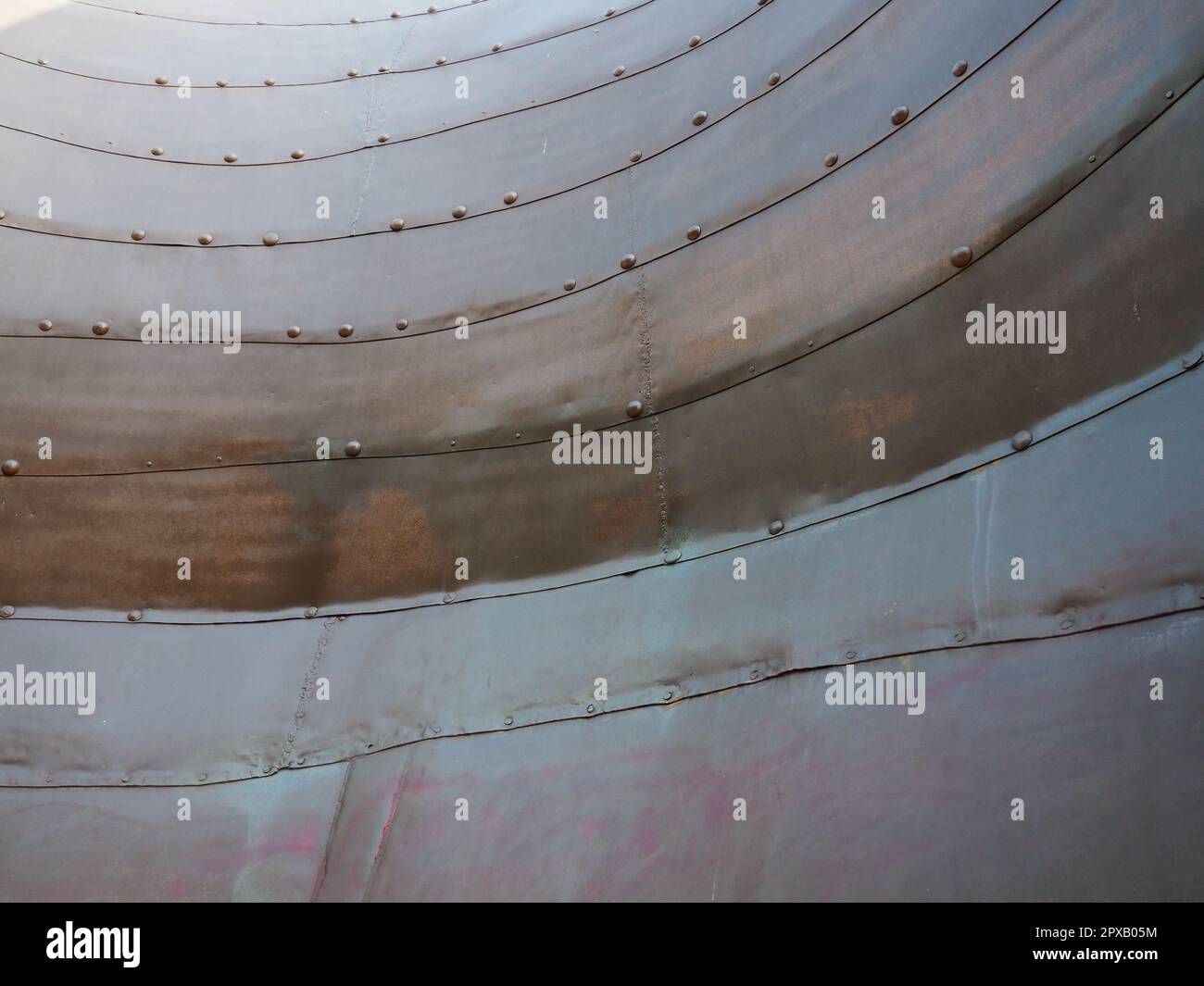 Metal surface with rivets and bolts. Abstract background of a military ...