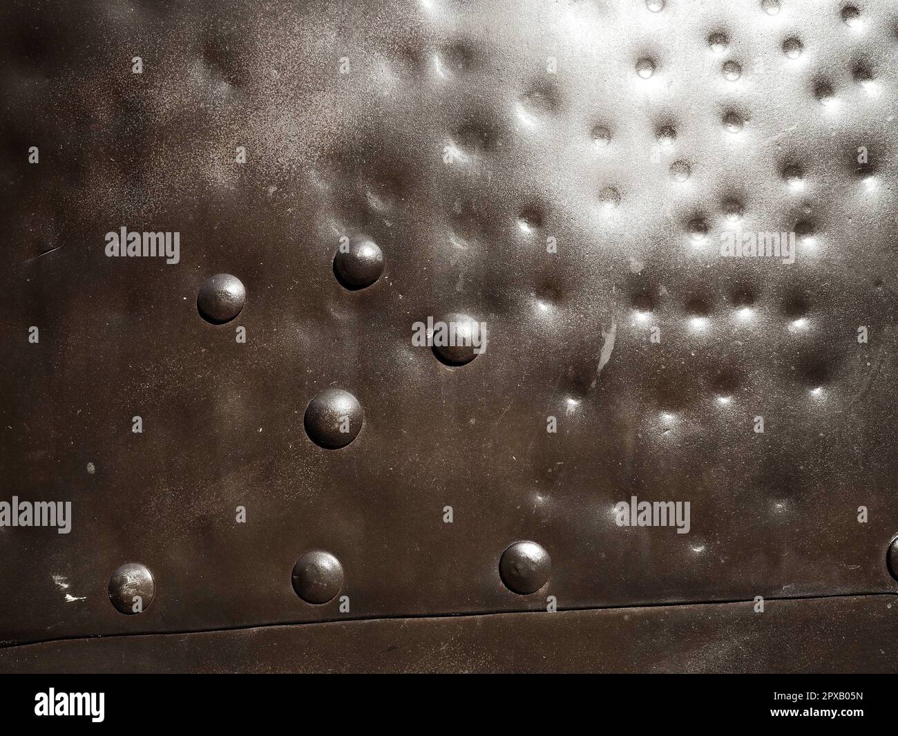 Metal surface with rivets and bolts. Abstract background of a military ...
