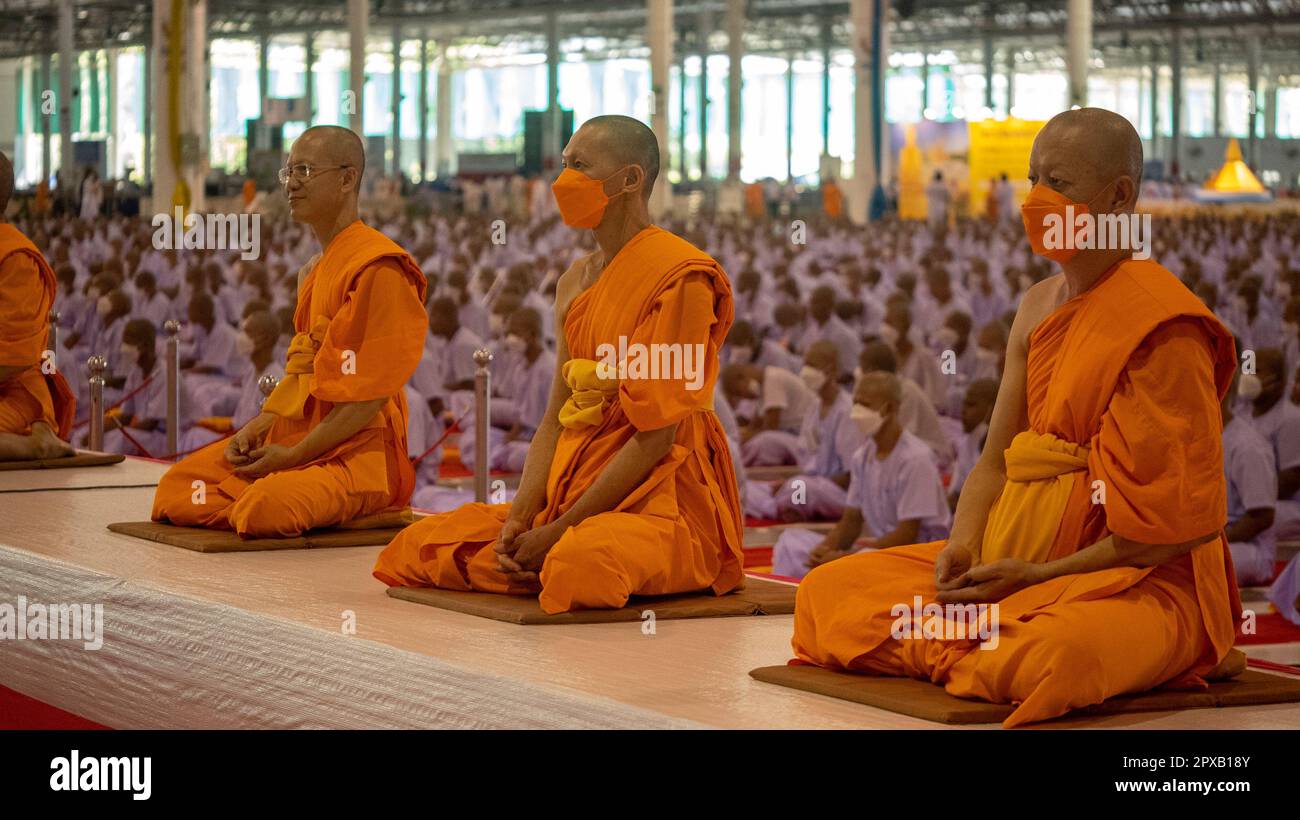 Devotees take part in the mass ordination ceremony at Wat Phra ...