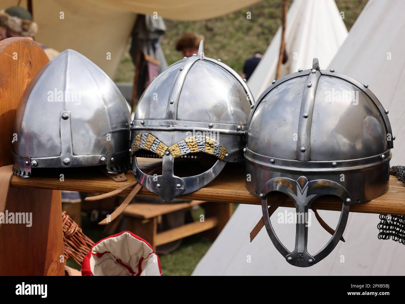 Medieval weapons, helmets in knight camp at the festival of historical ...