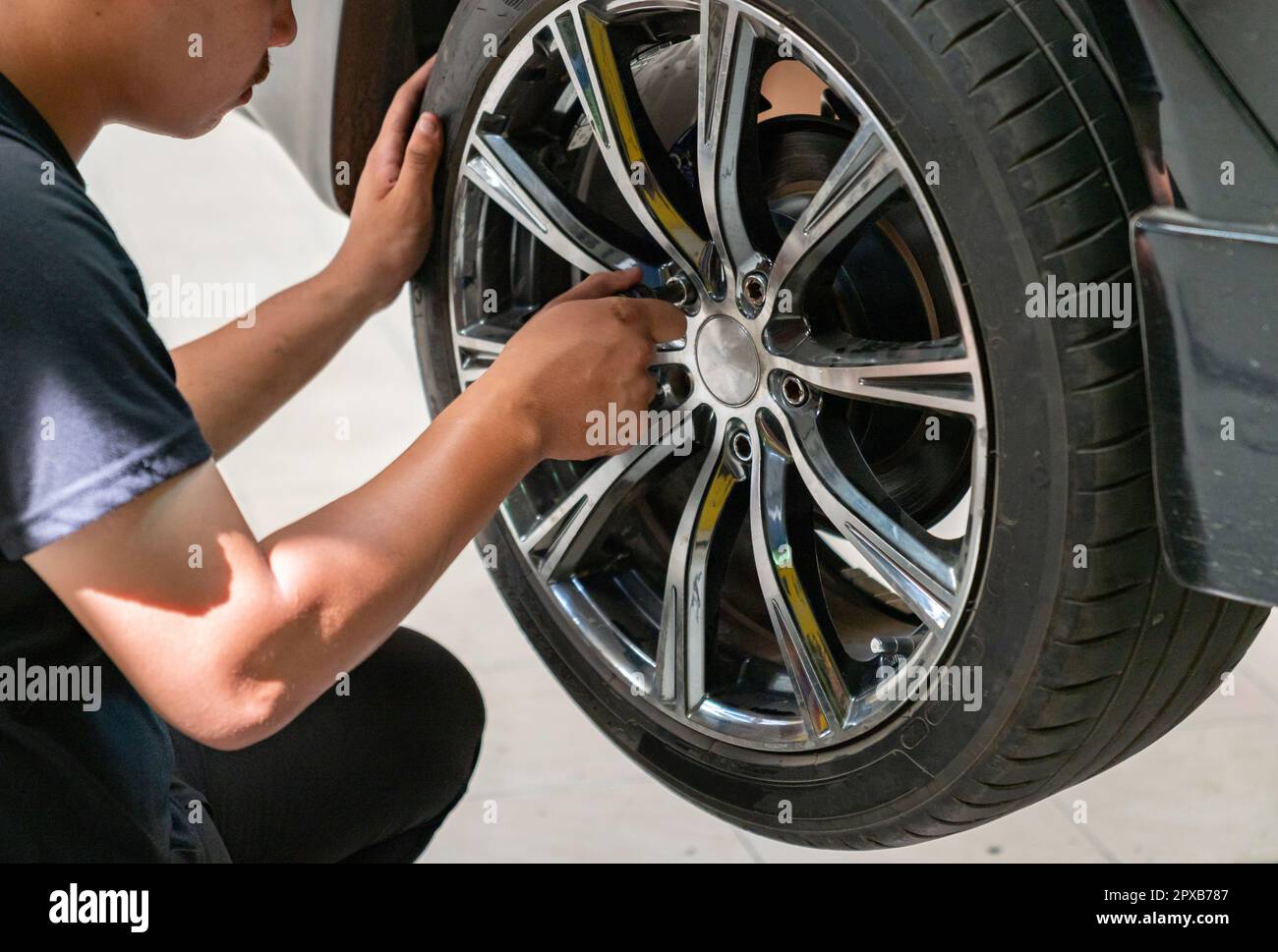 Technician check and repair wheels in service shops Stock Photo - Alamy