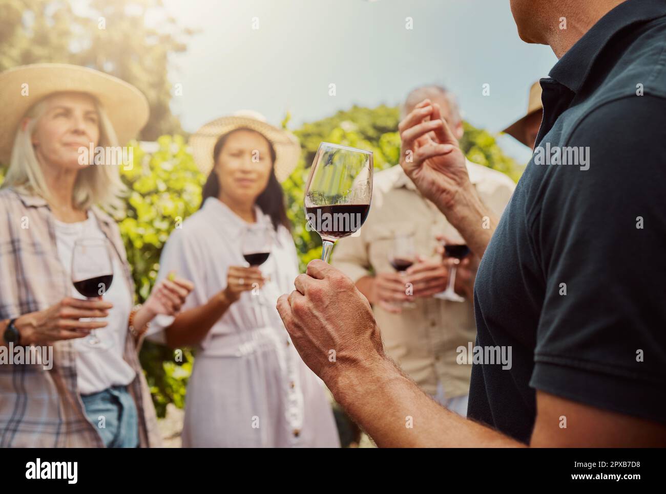 Farmer talking and explaining to diverse group of friends while holding ...