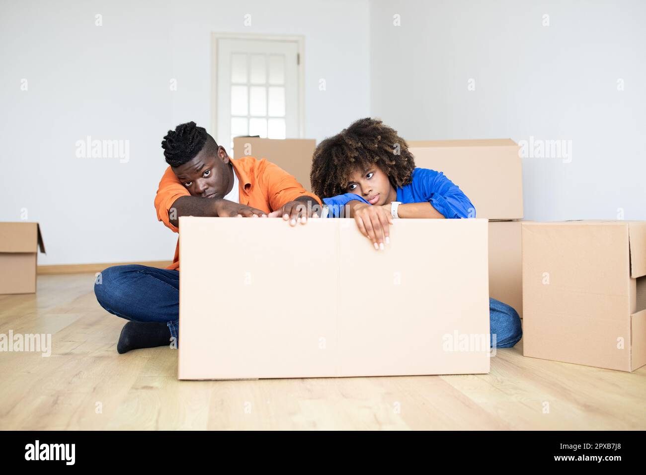 Upset Black Spouses Leaning At Cardboard Box, Feeling Tired While ...