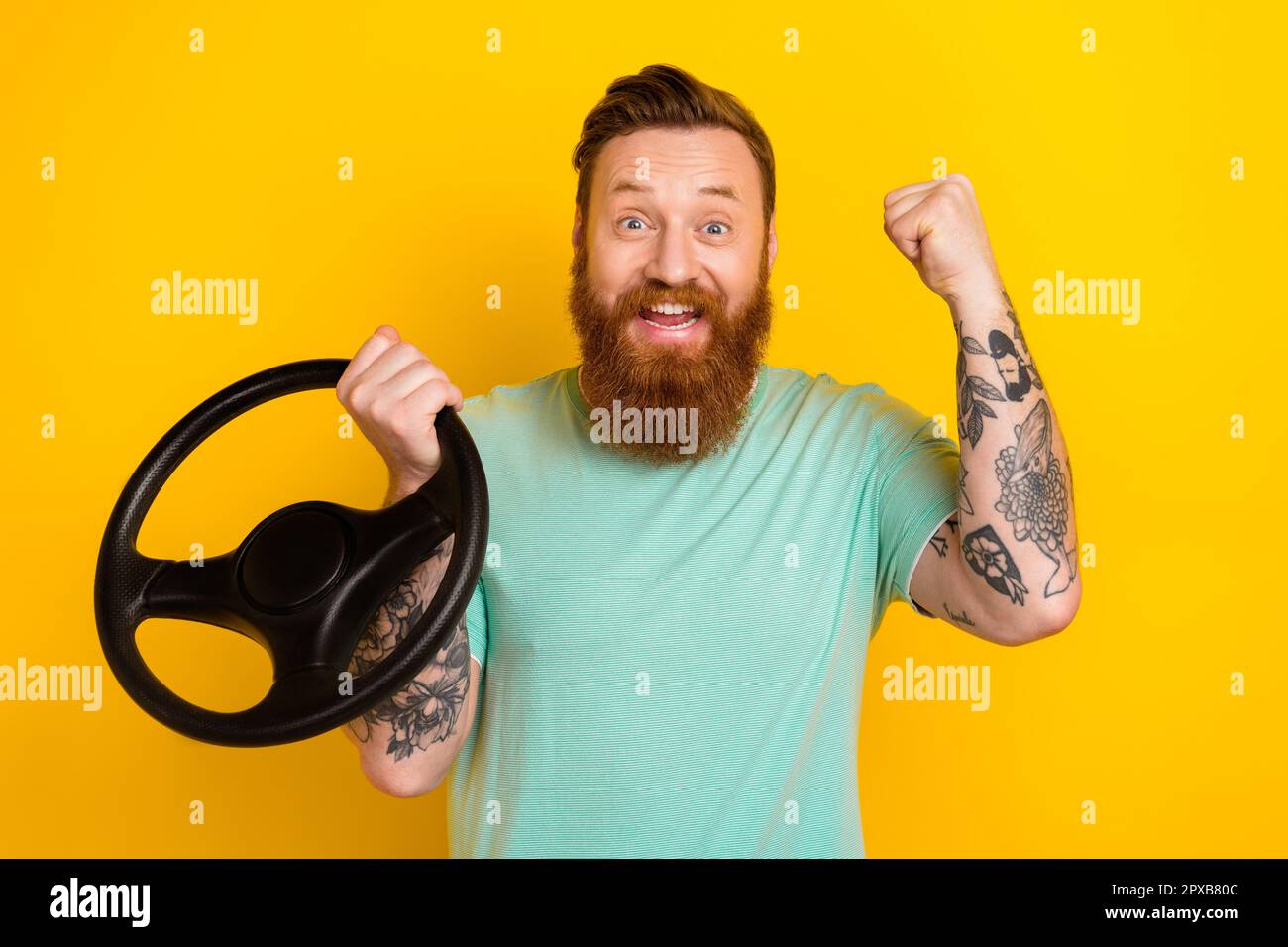 Portrait of funky excited person hold wheel raise fist accomplishment ...