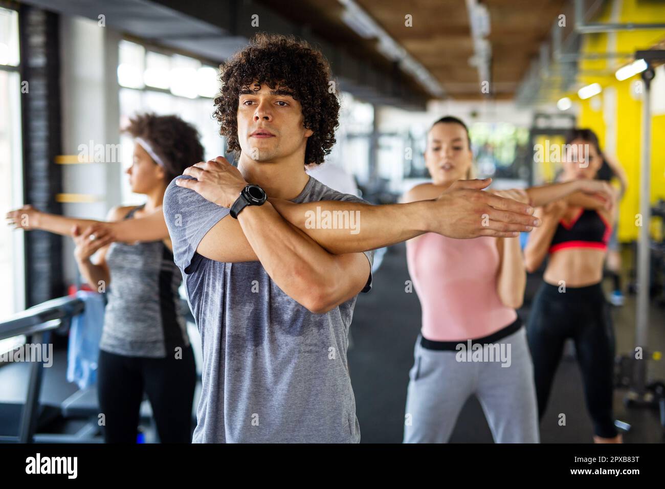 Group of fit people working out in a gym. Multiracial friends ...