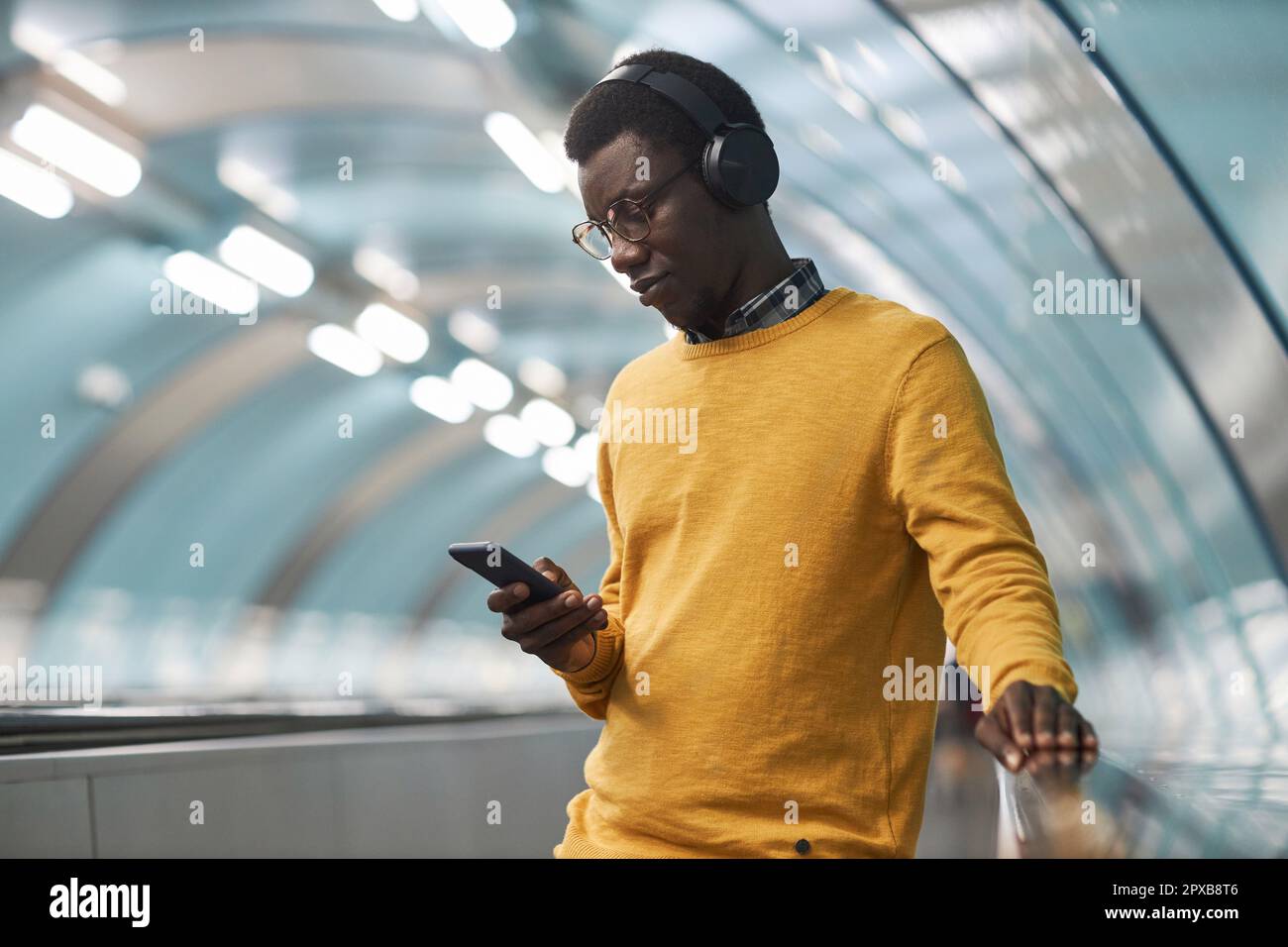 African American man in wireless headphones listening to music on ...