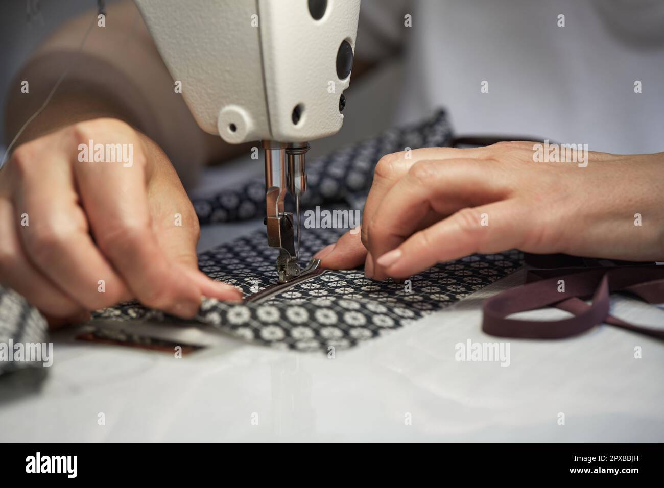 girl seamstress sew on the sewing machine. Women's hands sewing on the ...