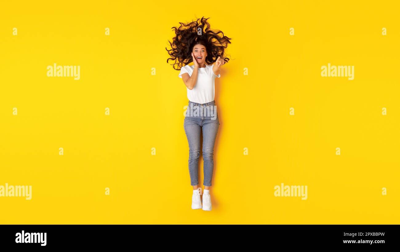 Top View Of Lady Pointing Finger At Camera, Yellow Background Stock ...