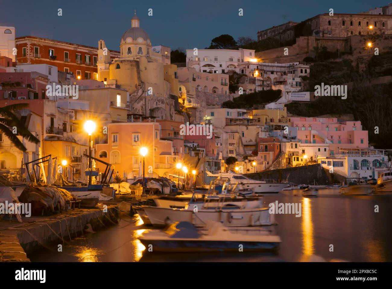 View of the Port of Corricella with lots of colorful houses at night in ...