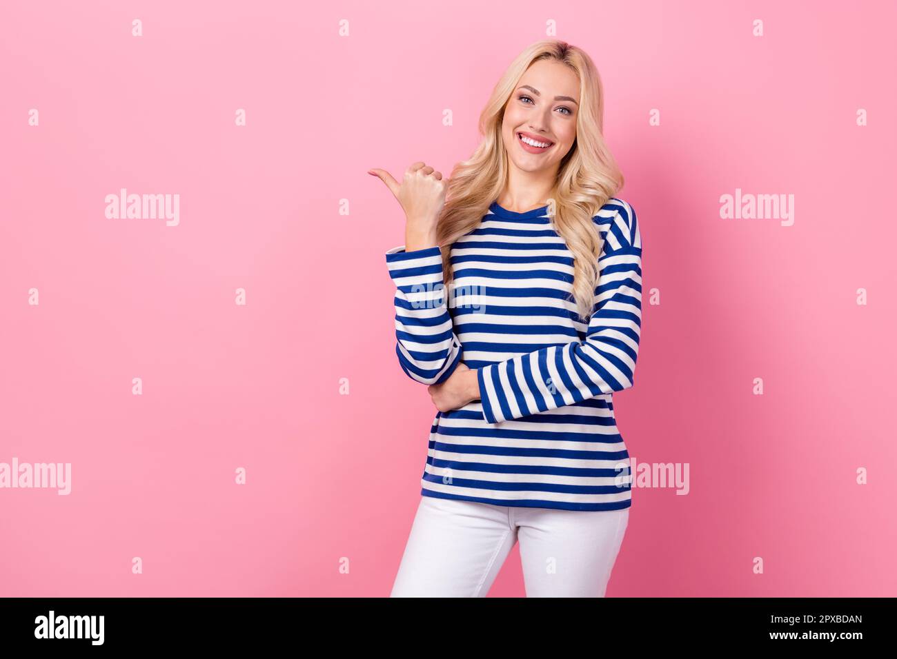 Photo of young promoter girl wear striped pullover point finger empty ...