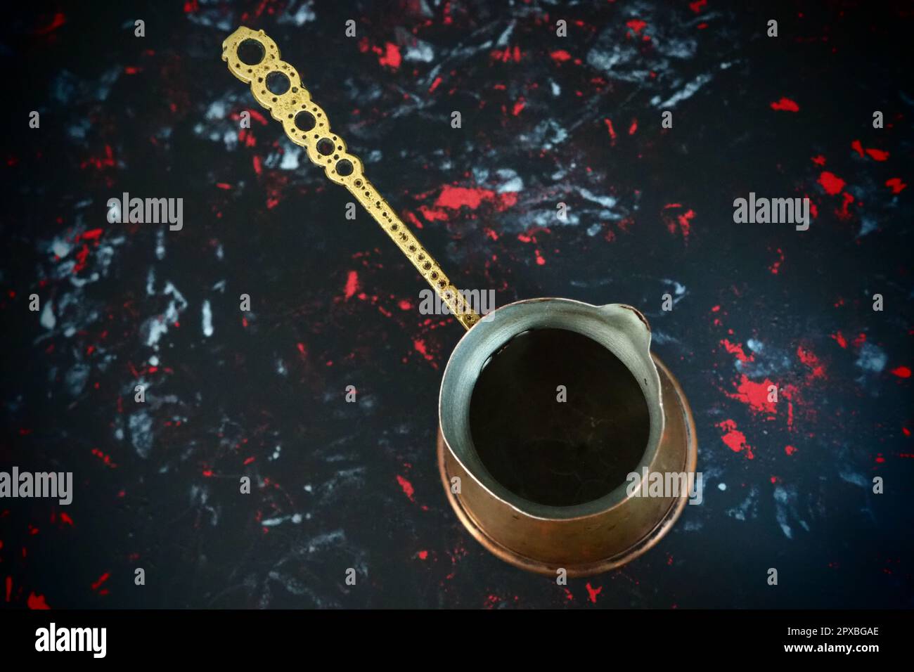 Balkan cezve for turkish coffee. A copper cezve on black surface ...