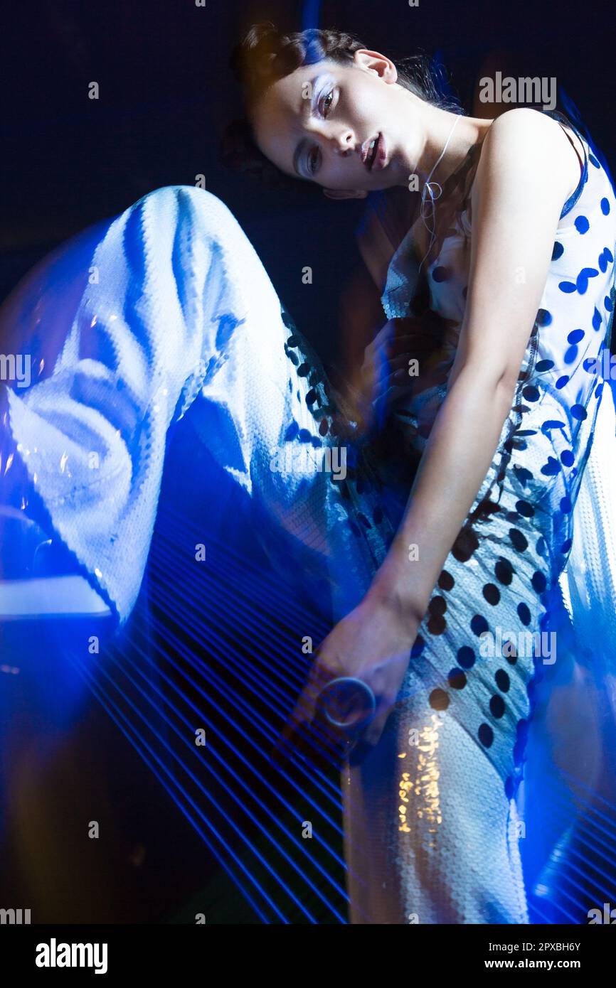 Fashion model beautiful girl in fashionable clothes in ultraviolet ...