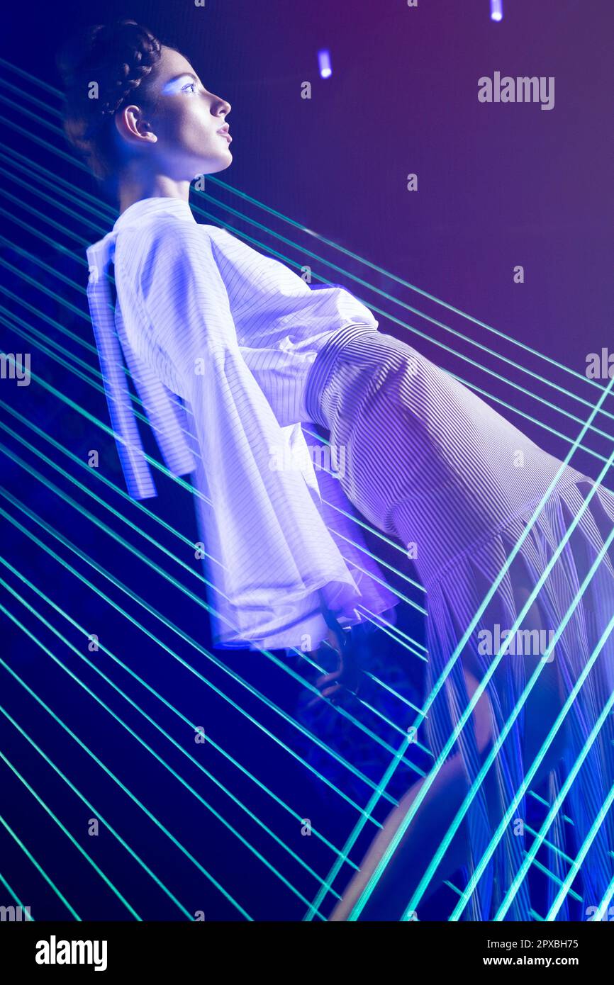 Fashion model beautiful girl in fashionable clothes in ultraviolet ...