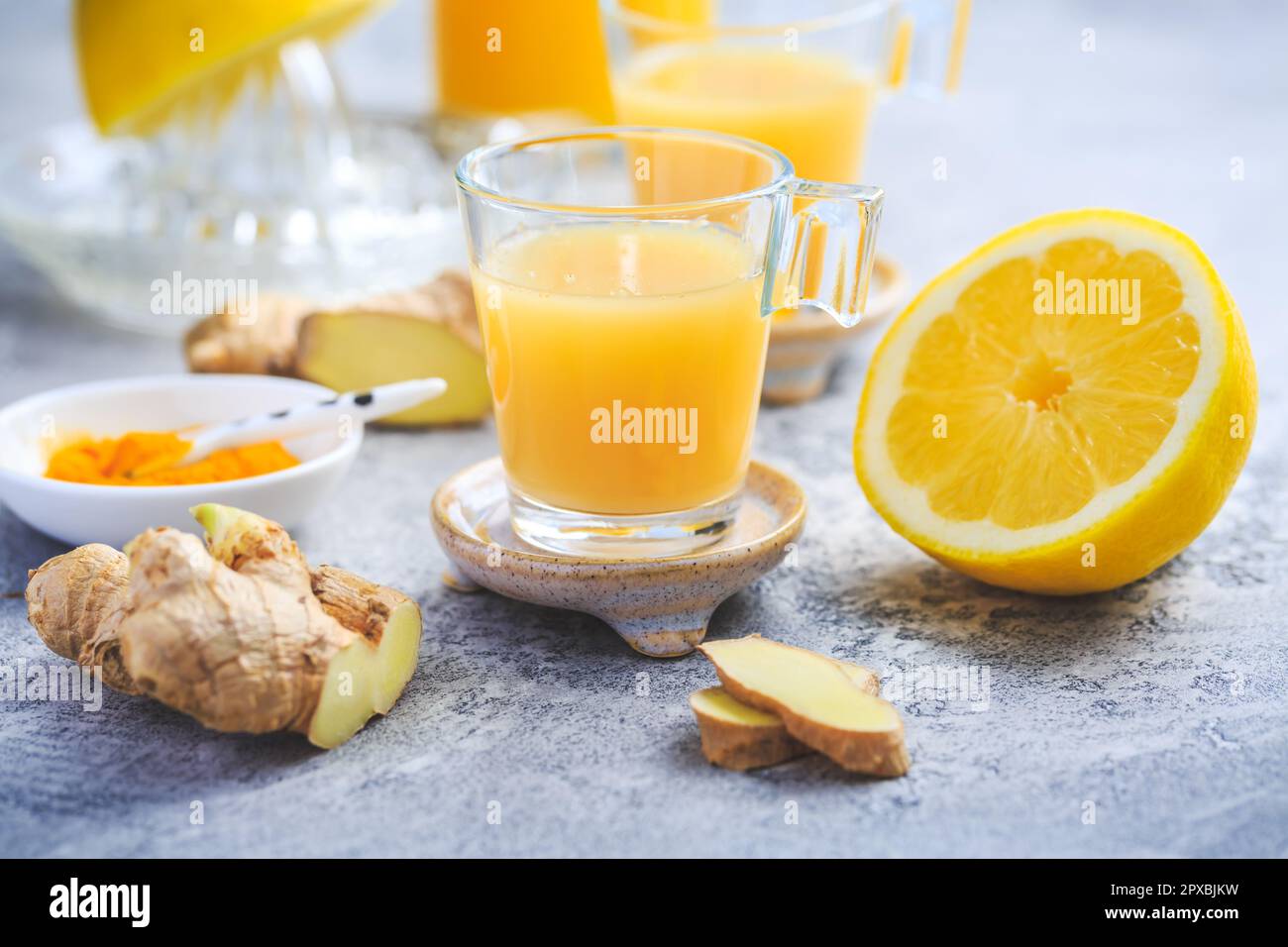 Homemade turmeric lemon ginger shots in small glasses, healthy Ginger ...