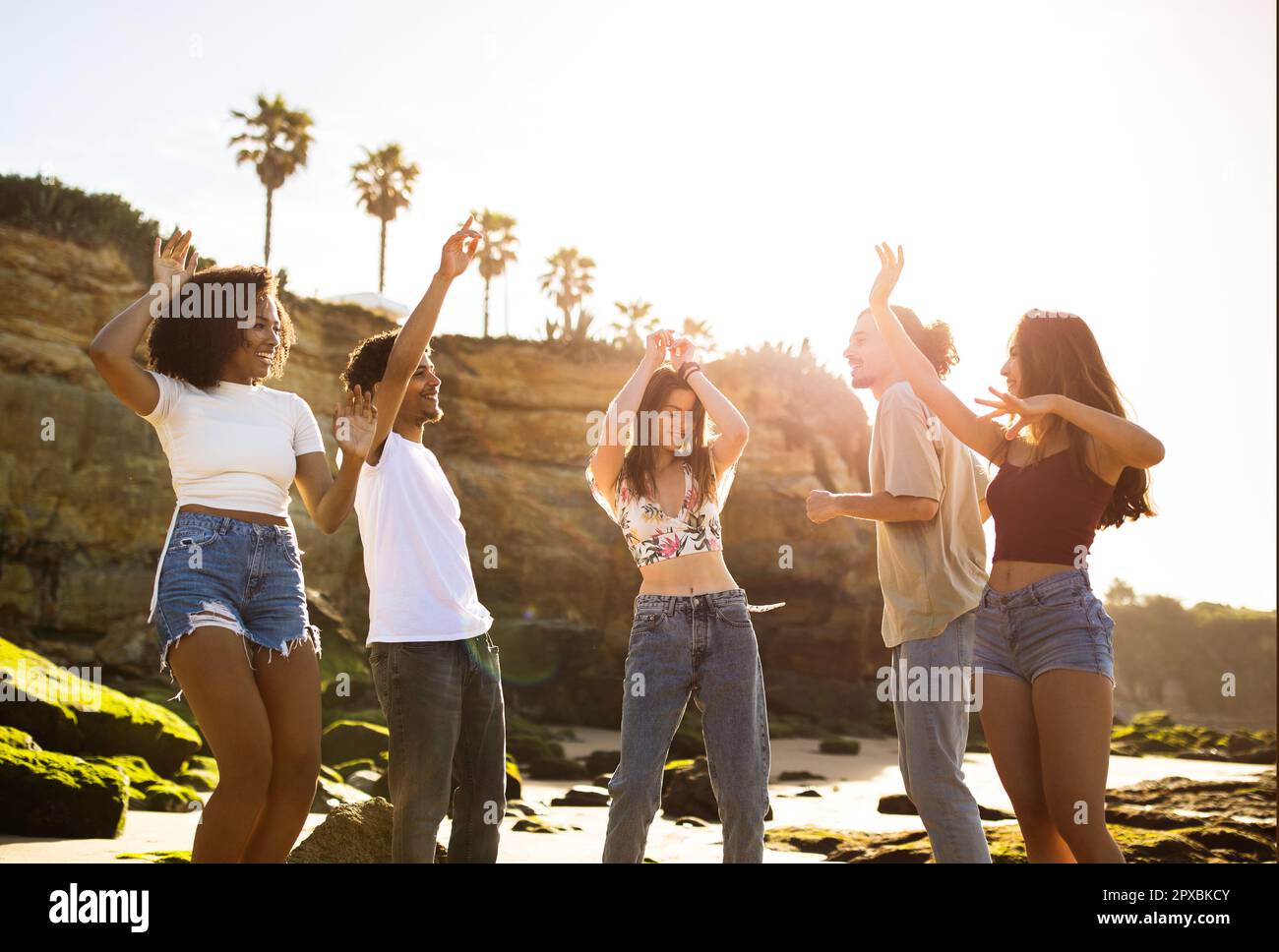 Glad excited young multiracial people enjoy music, dance, have fun ...