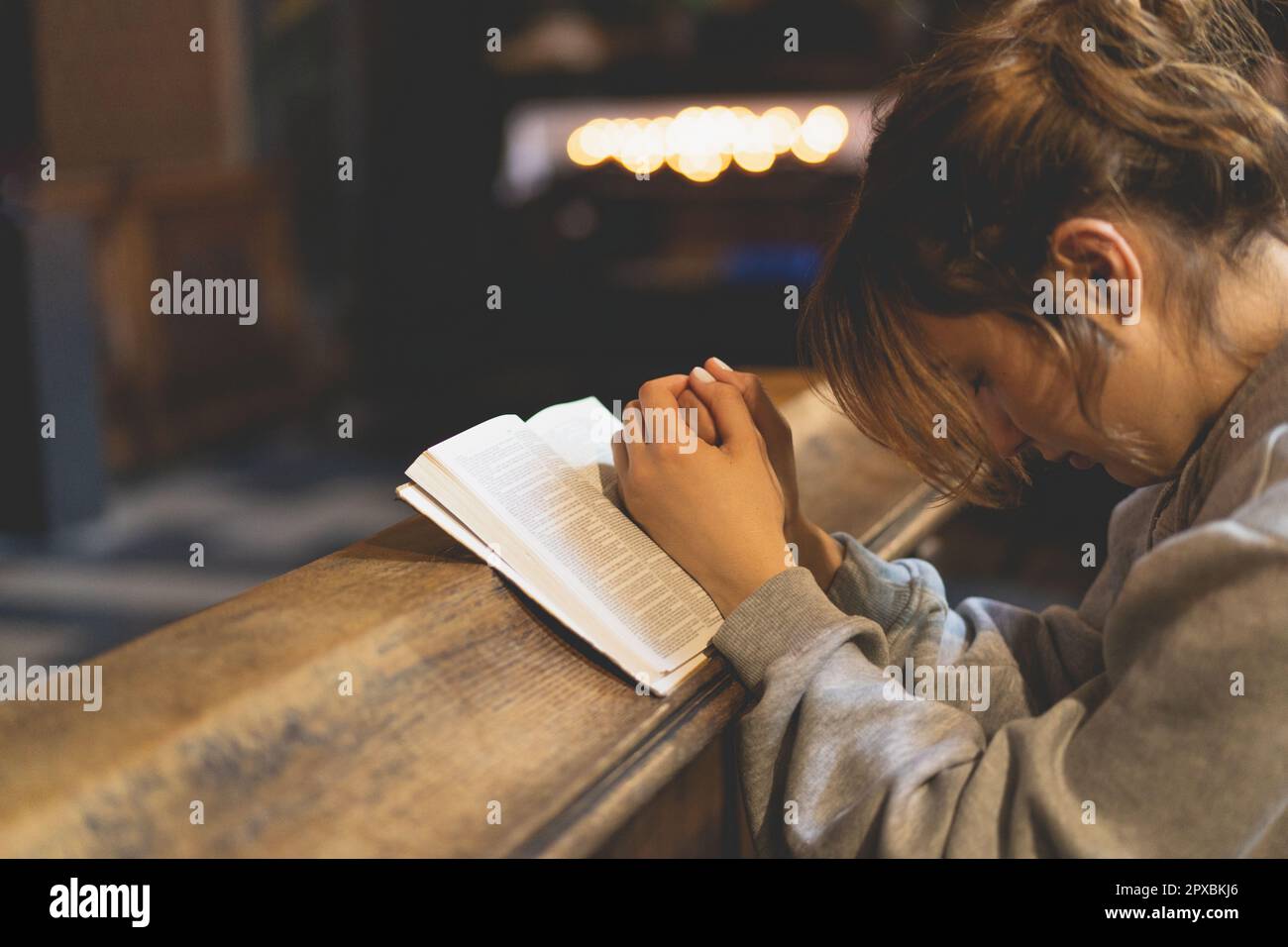 Christian woman reading bible in an ancient Catholic temple. Reading the Holy Bible in temple ...