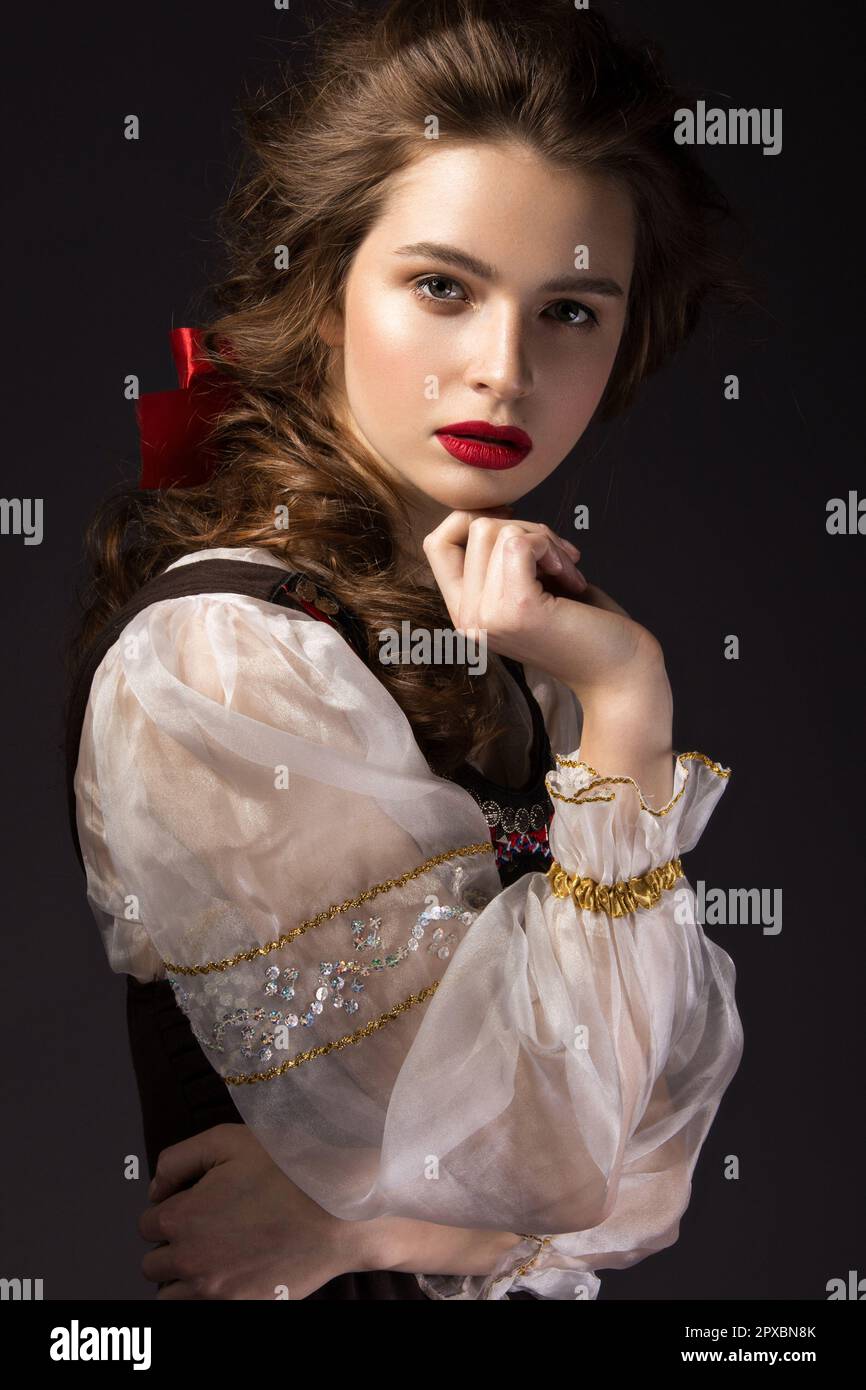 Beautiful Russian girl in national dress with a braid hairstyle and red ...