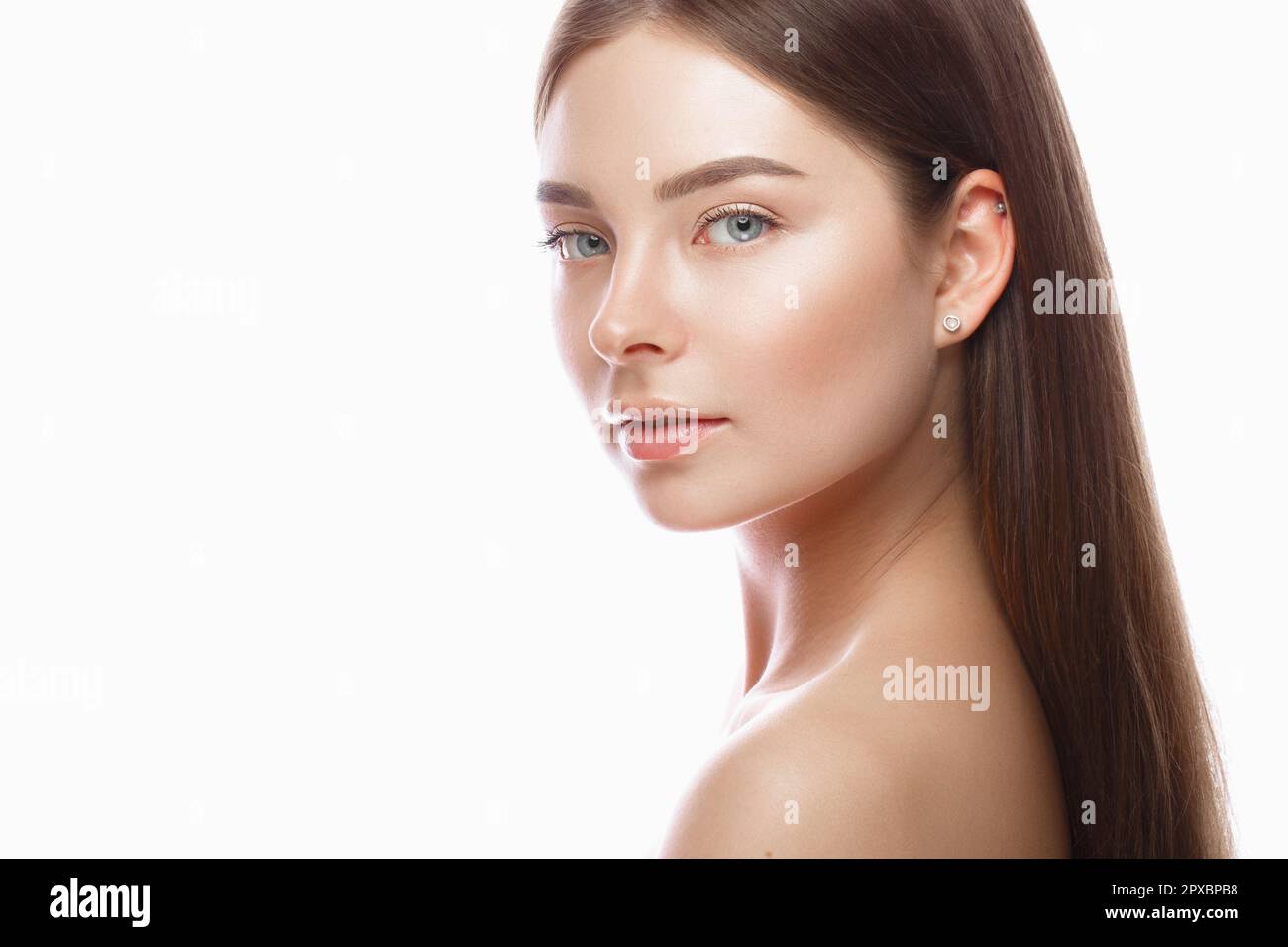 Beautiful young girl with a light natural make-up and perfect skin ...