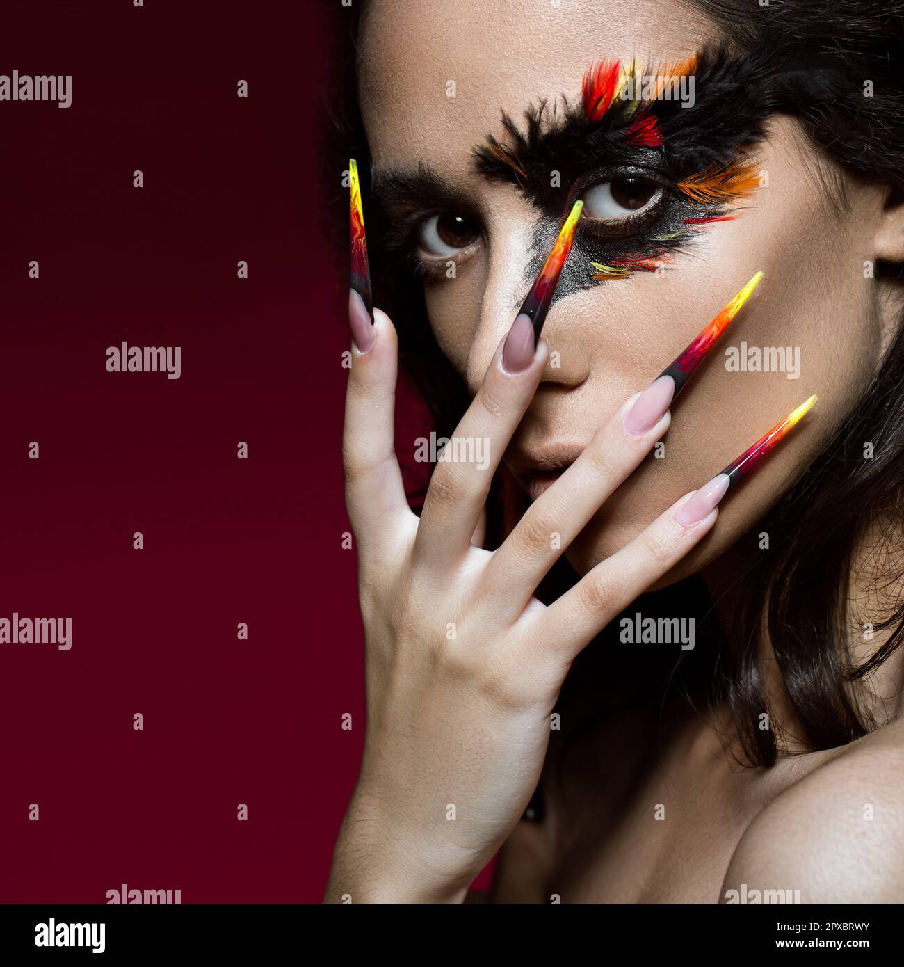 Beautiful girl in the image of the Phoenix bird with creative makeup ...