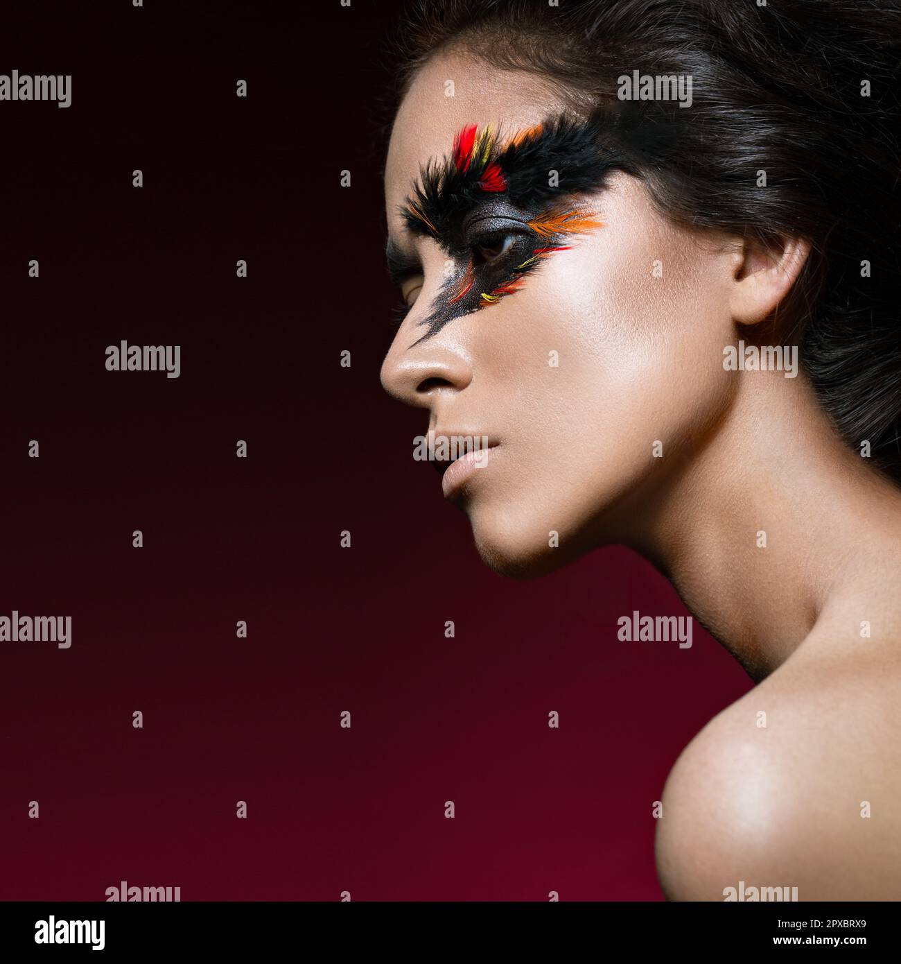 Beautiful girl in the image of the Phoenix bird with creative makeup ...