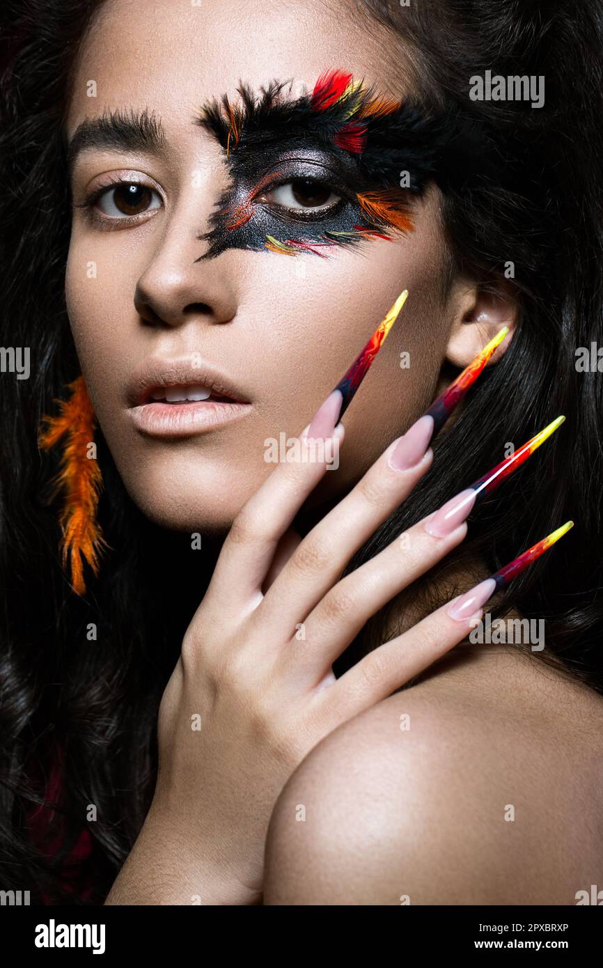 Beautiful girl in the image of the Phoenix bird with creative makeup ...