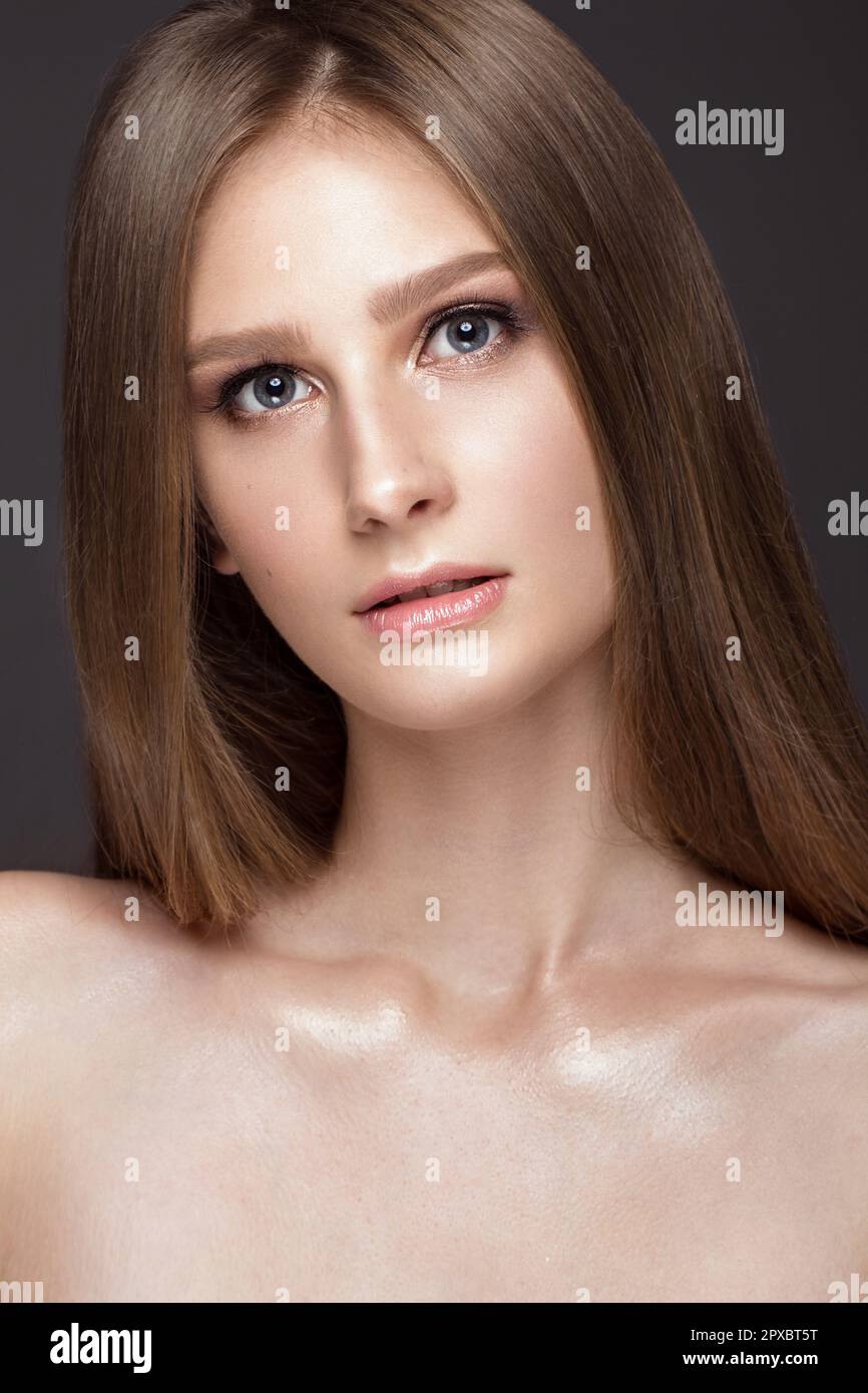 Beautiful young girl with a light natural make-up and perfect skin ...