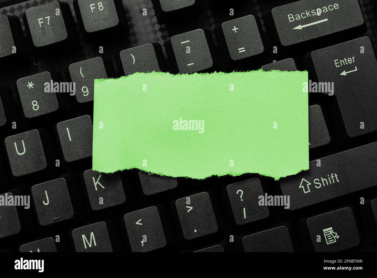 Colored sticker lying on keyboard. Important message written over paper ...