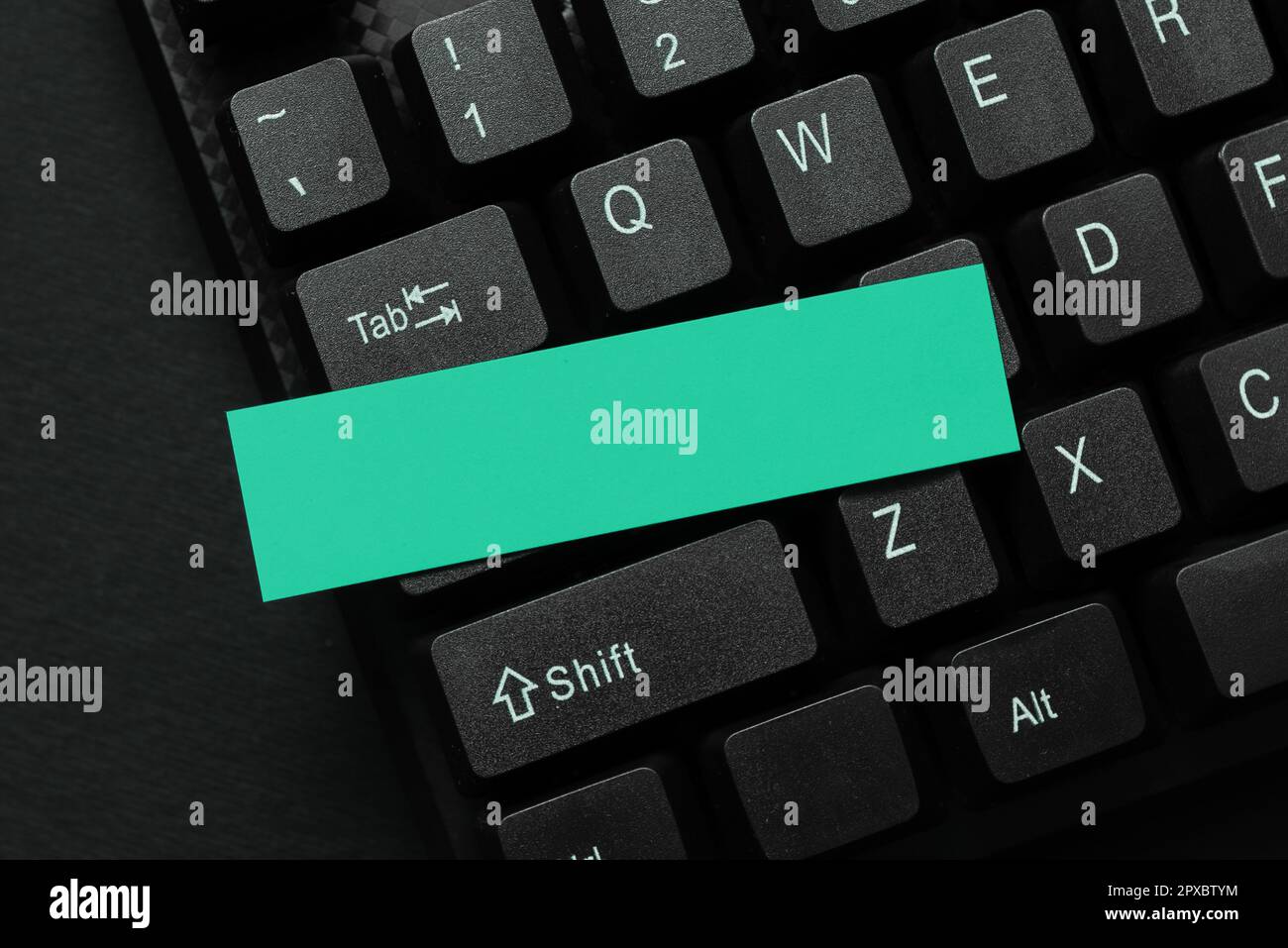 Colored sticker lying on keyboard. Important message written over paper ...