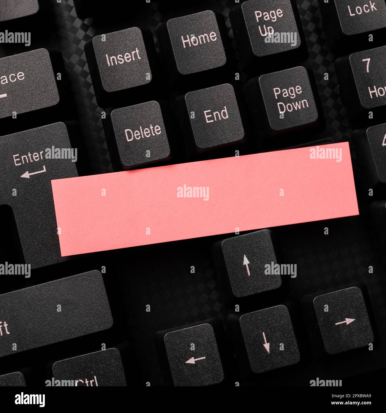 Sticker lying on black keyboard. Important message written over paper ...