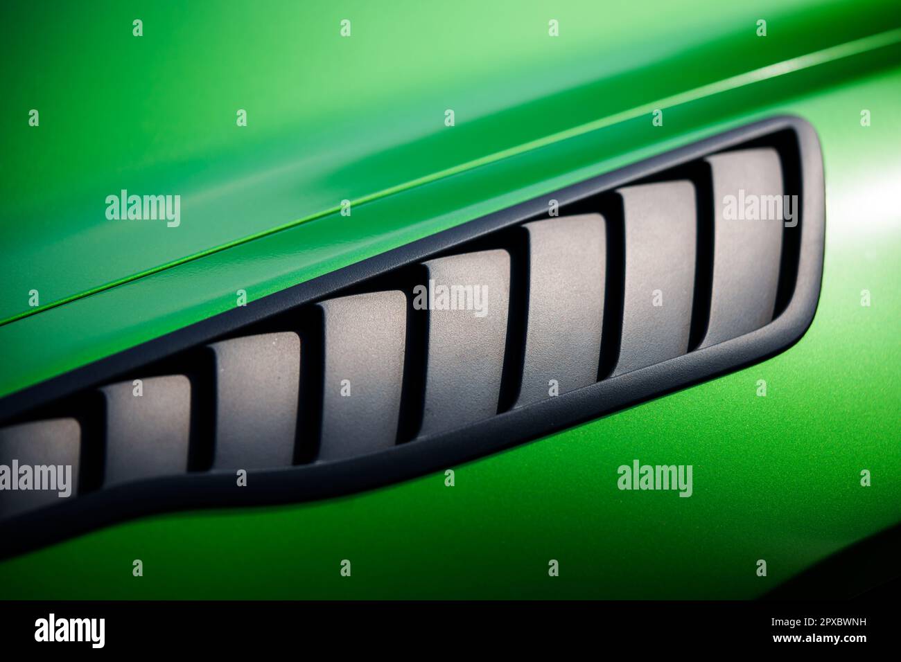 Aerodynamic green exotic supercar detail of gloss carbon part with ...