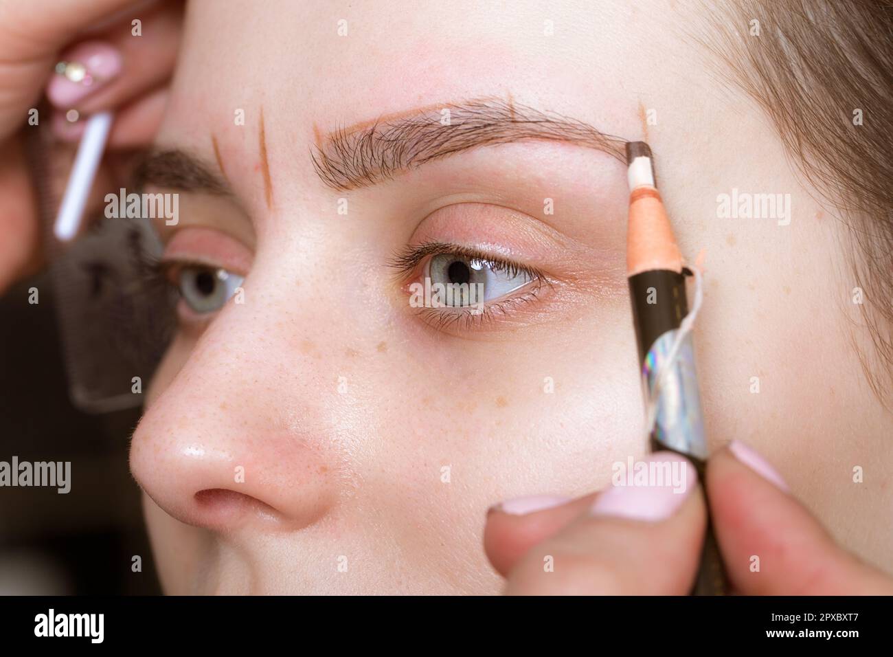 Permanent microblasting tattooing freckles to a woman in a beauty salon ...